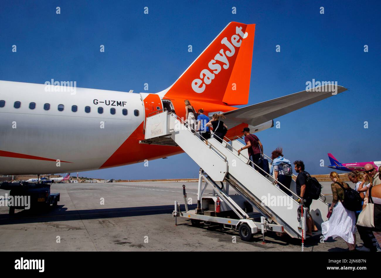 Passengers boarding an easyJet aircraft at Santorini airport Stock ...