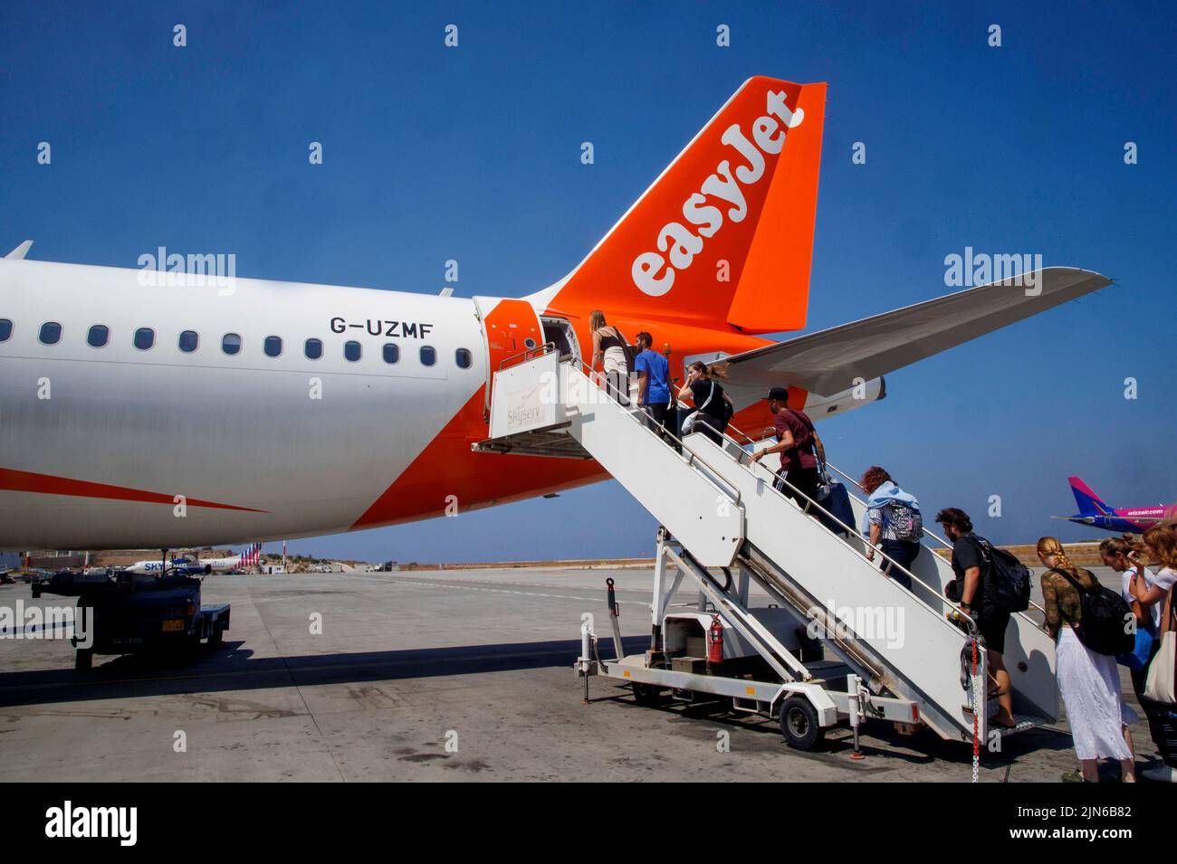 Passengers boarding an easyJet aircraft at Santorini airport Stock ...