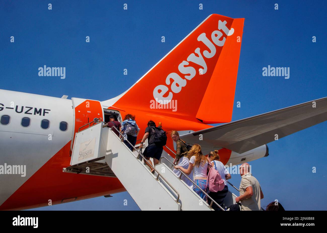 Passengers boarding an easyJet aircraft at Santorini airport Stock ...