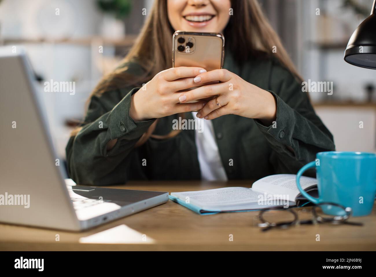 Cropped view of female employer sitting at table and using modern ...