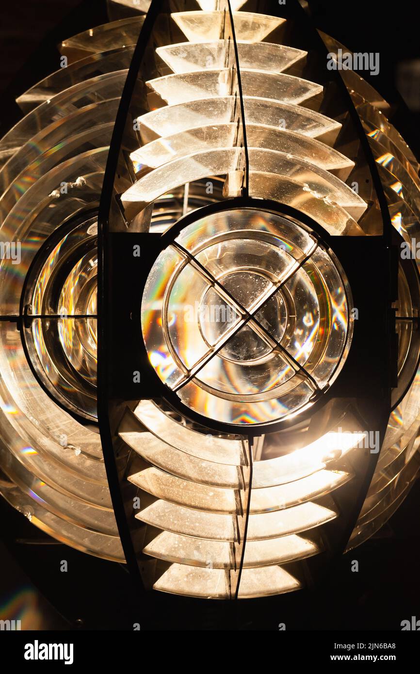 Bright lighthouse lamp with a Fresnel lens. Close up vertical photo. It ...