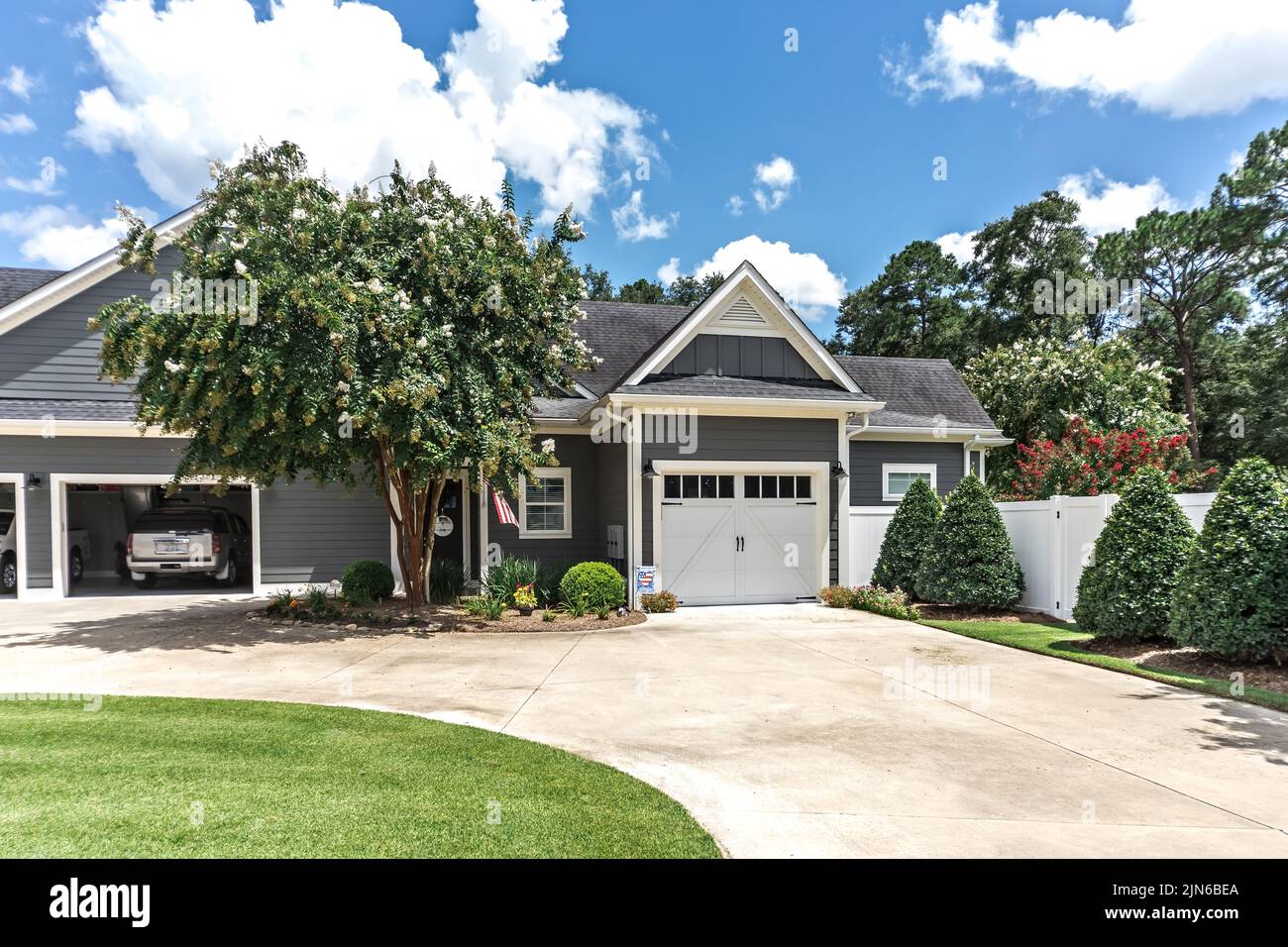 Low angle view of the side of a large gray craftsman new construction ...