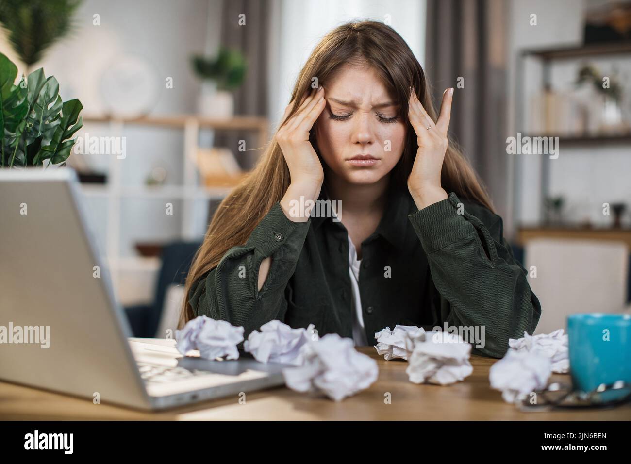 Caucasian young woman stressed about work at home office and look at ...