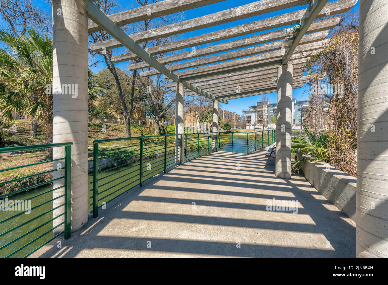 Walkway with pergola roof beside a river at San Antonio, Texas. There ...