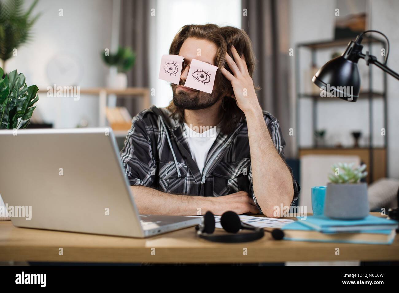 A lot of work concept. Tired caucasian male student sleeping with ...