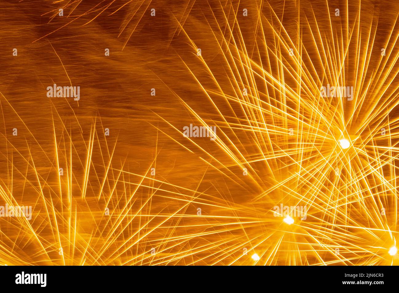 abstract holiday background: yellow fireworks in night sky Stock Photo ...