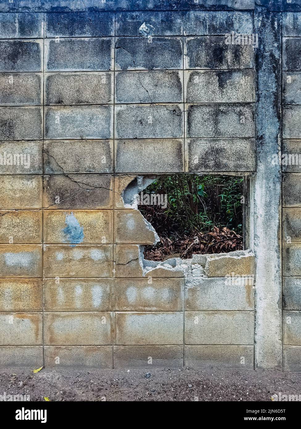 Dirty old eroded cracked plaster cement block fence. Concrete block ...