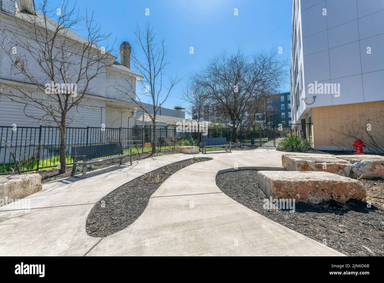 Pathway with benches and large concrete blocks on the side near the ...