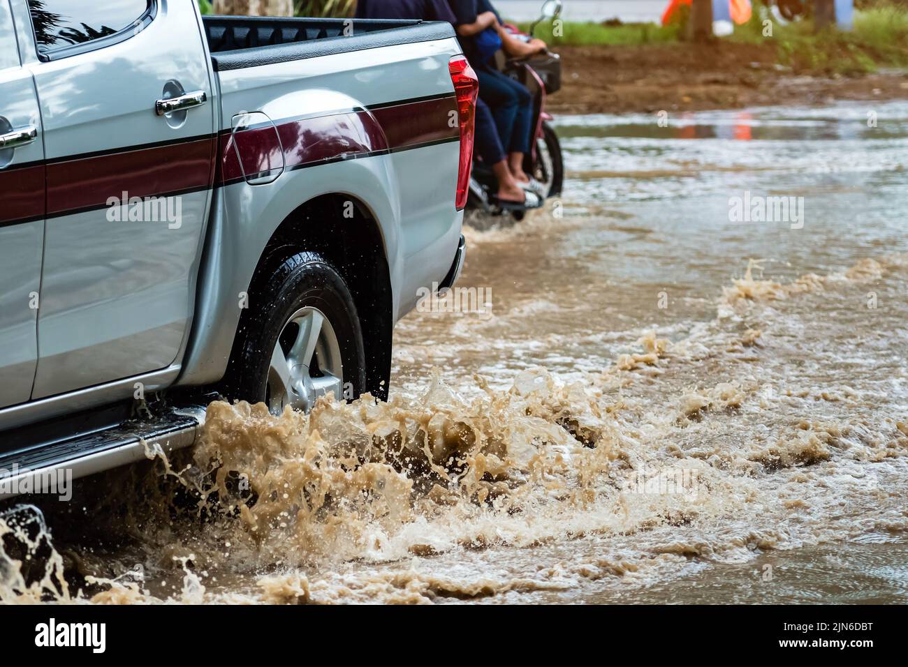 Pickup truck passing through flooded road. Driving car on flooded road ...