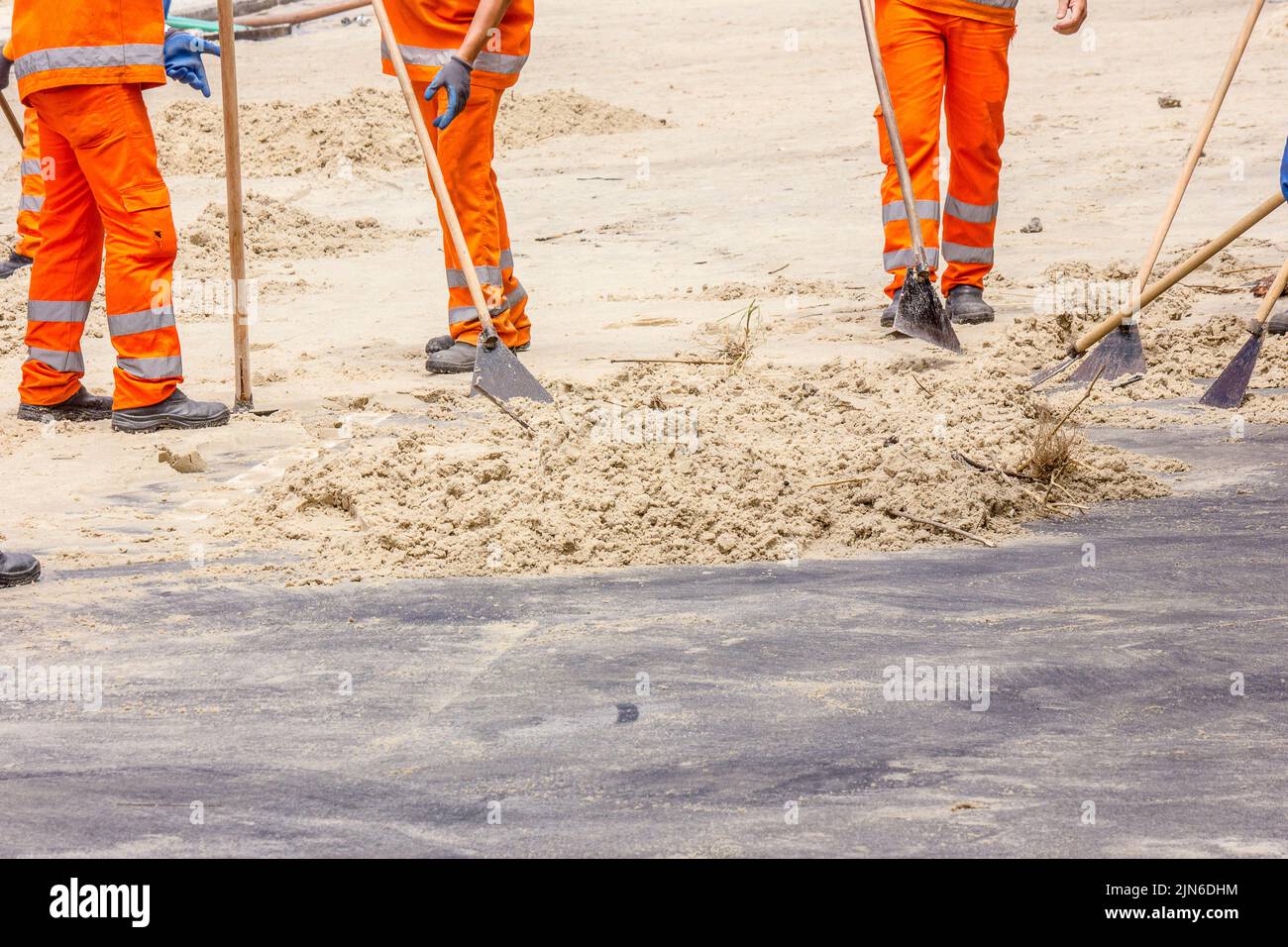 men removing sand from the boardwalk after the hangover Stock Photo - Alamy