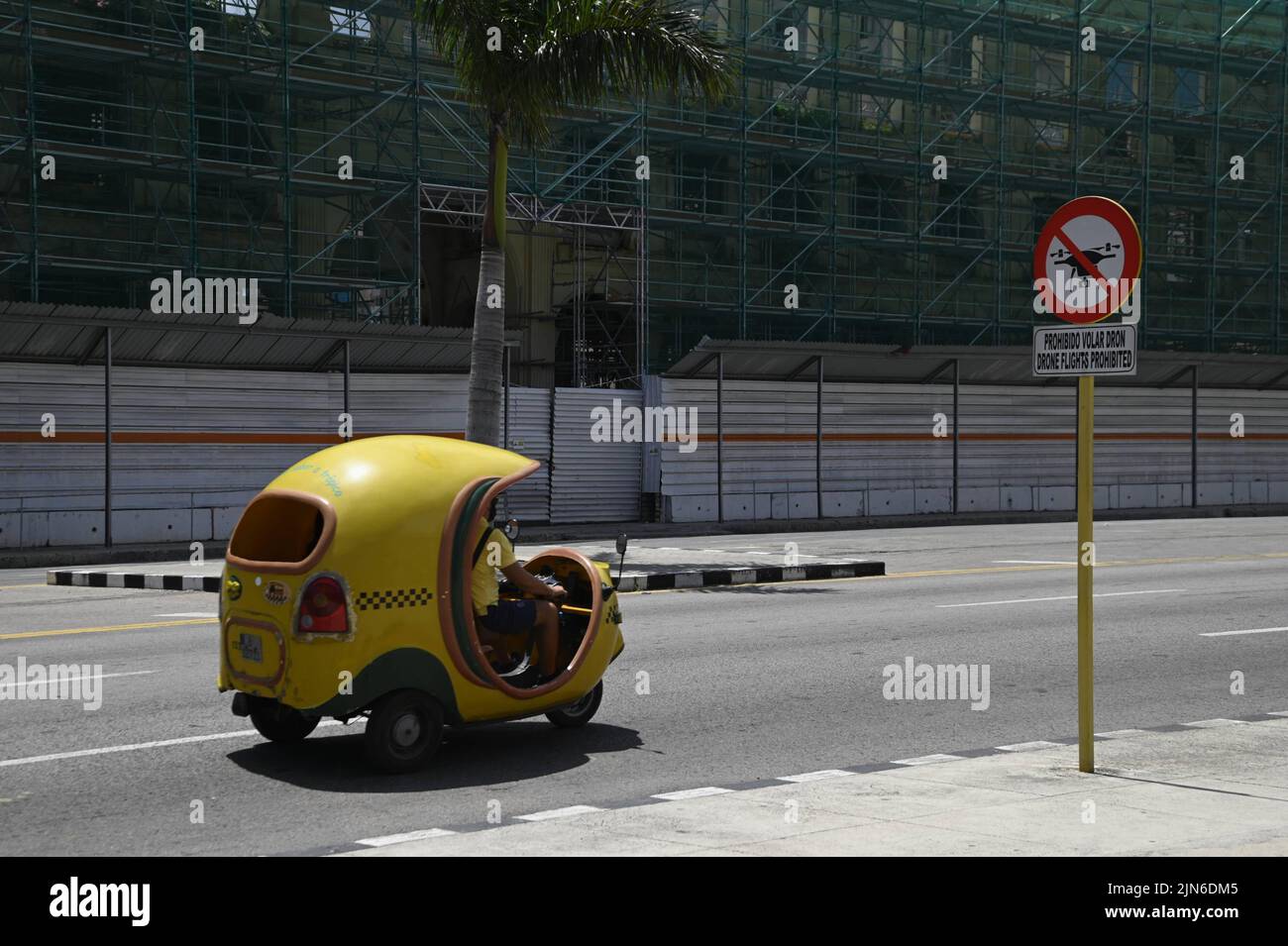 Cityscape with scenic view of a typical Coco-taxi the traditional rickshaw-type taxi vehicle on ...