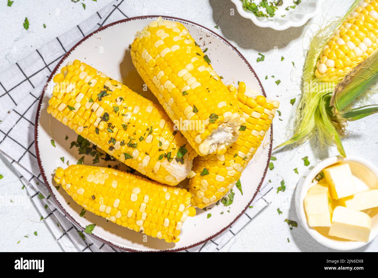 Boiled corn with butter and herbs. Ripe yellow organic cooked corn cobs ...