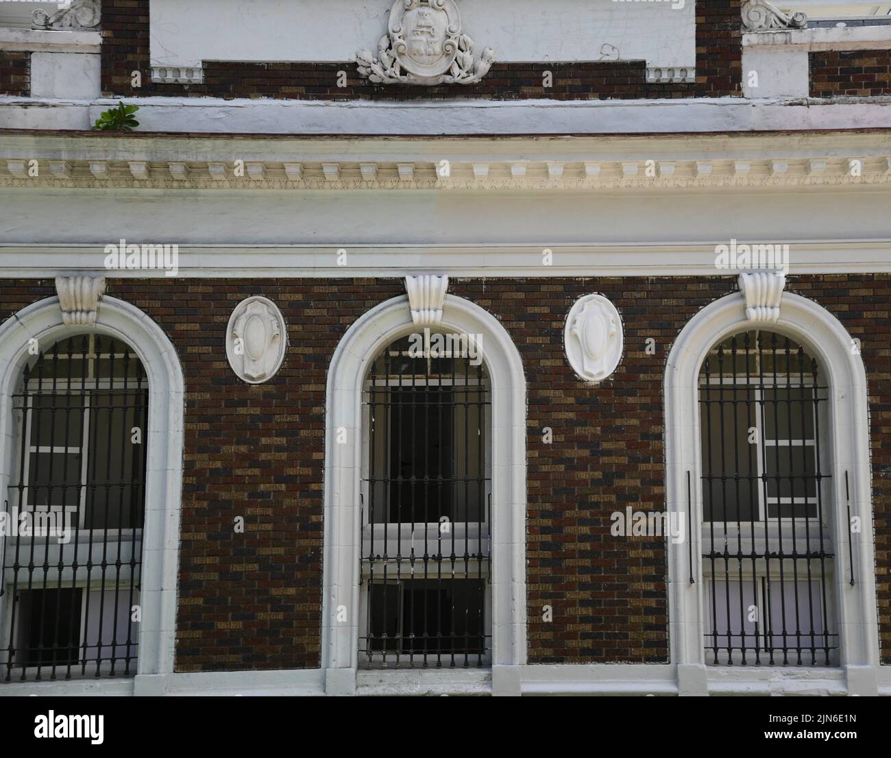 Old Spanish Colonial building with arched windows and handcrafted ...
