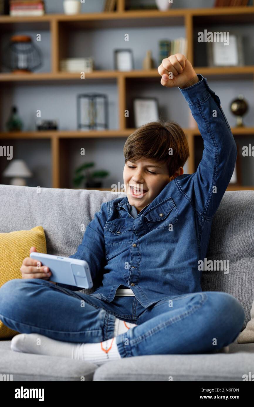 Teens and gaming addiction. Young boy playing video game on smartphone ...