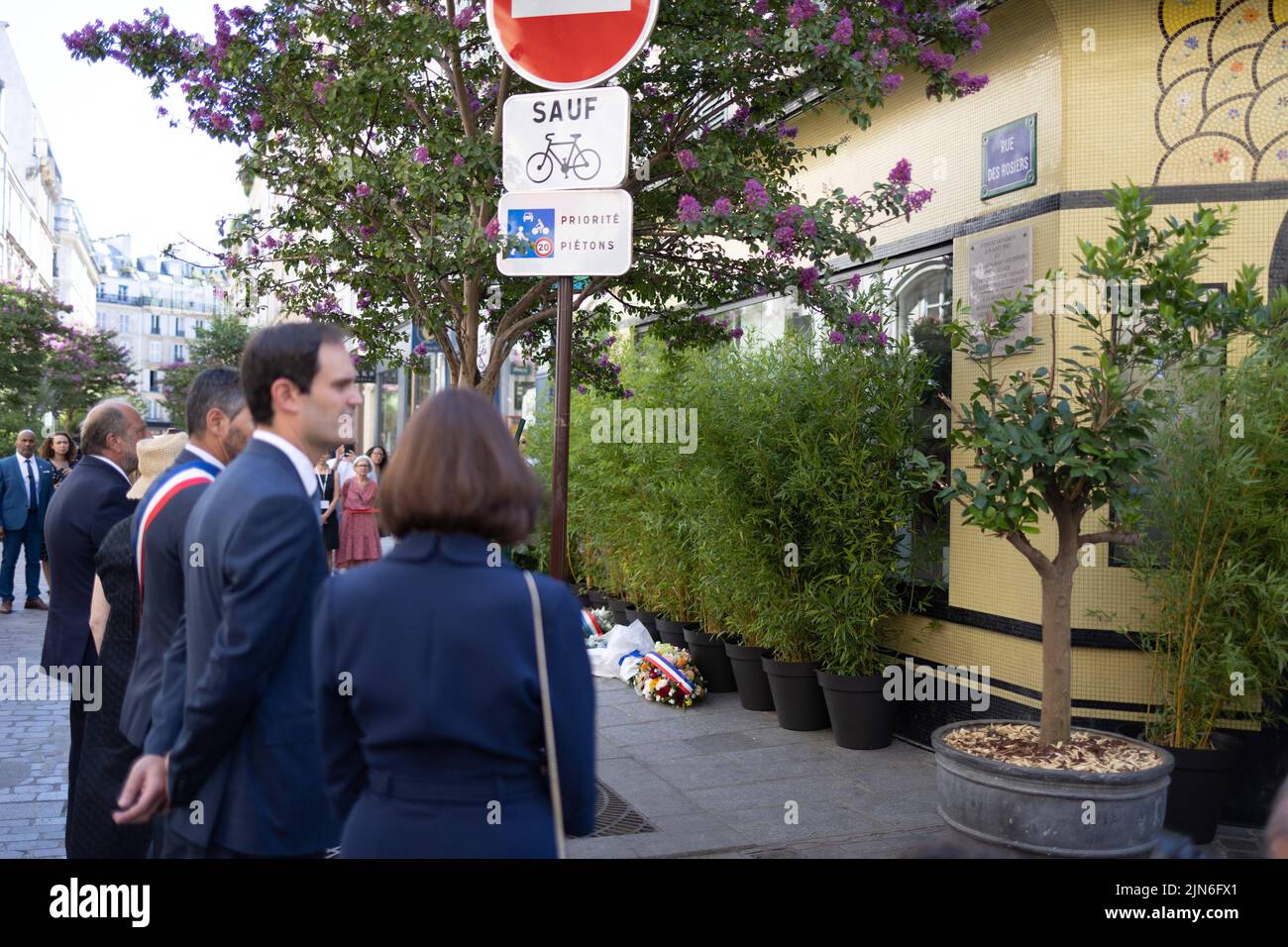 Personalities stands in front of the Rue Des Rosiers plaque during the ...