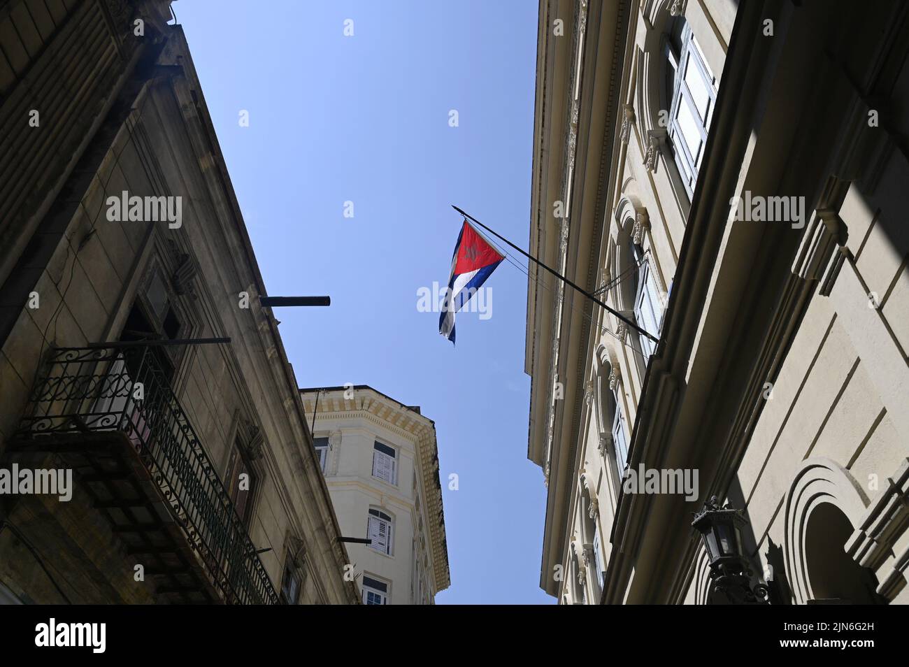 Cityscape with view of old Colonial buildings and a weaving Cuban flag ...