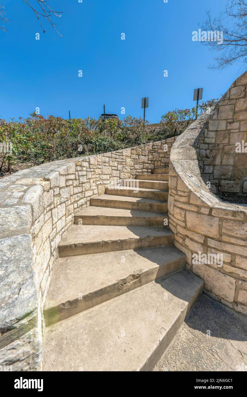 Outdoor staircase with stone walls and concrete steps at San Antonio ...