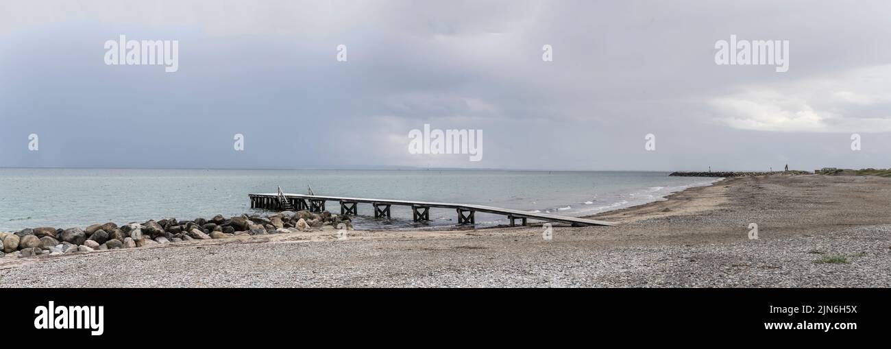 landscape with little pier on stony beach at shore of Kattegat sea ...