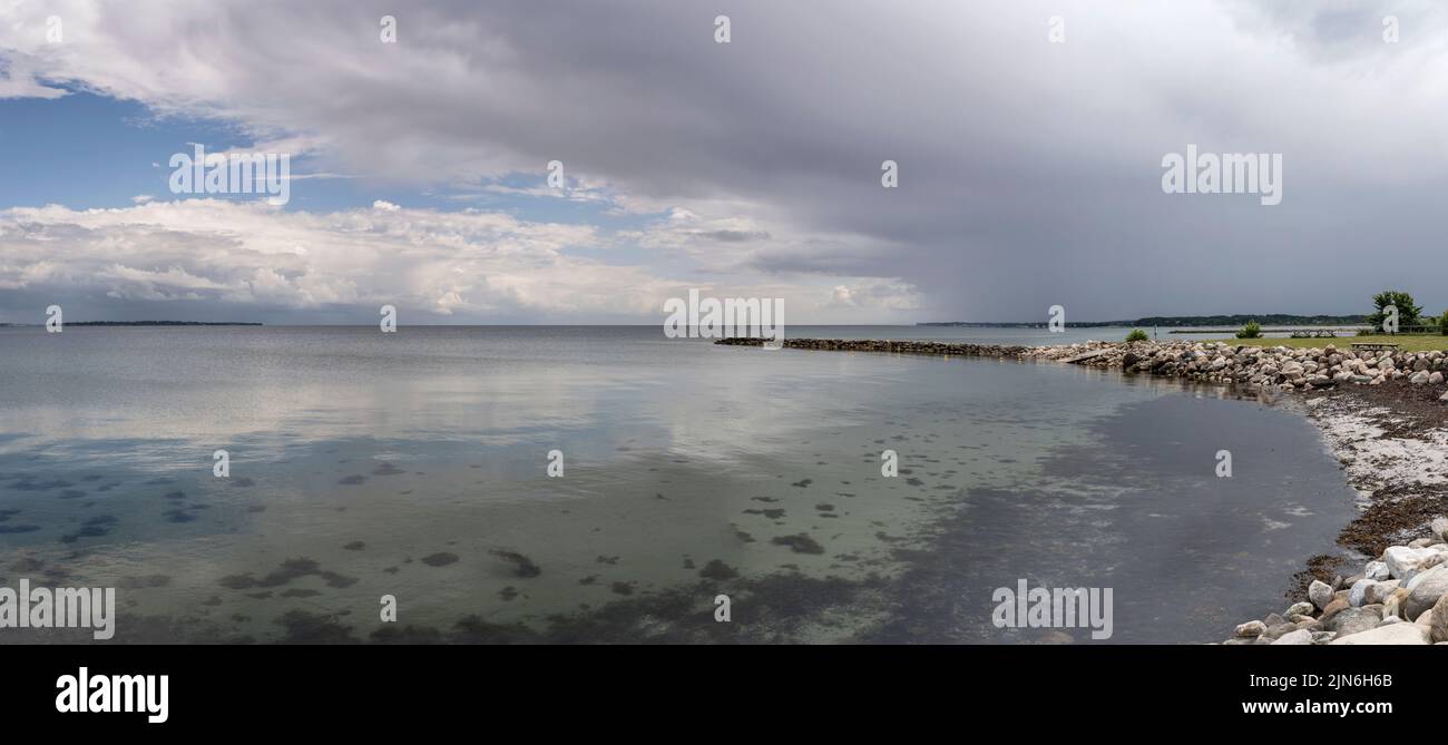 landscape with shallow waters on shore of Oresund sea, shot in stormy ...