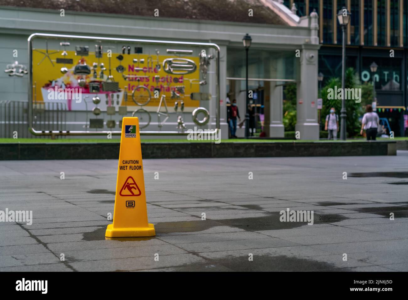 A warning caution wet floor sign at Raffles Place, Singapore Stock ...