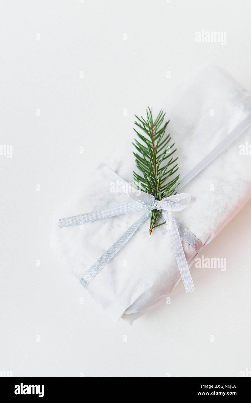 A homemade Christmas stollen sealed in white craft paper, along with a ...
