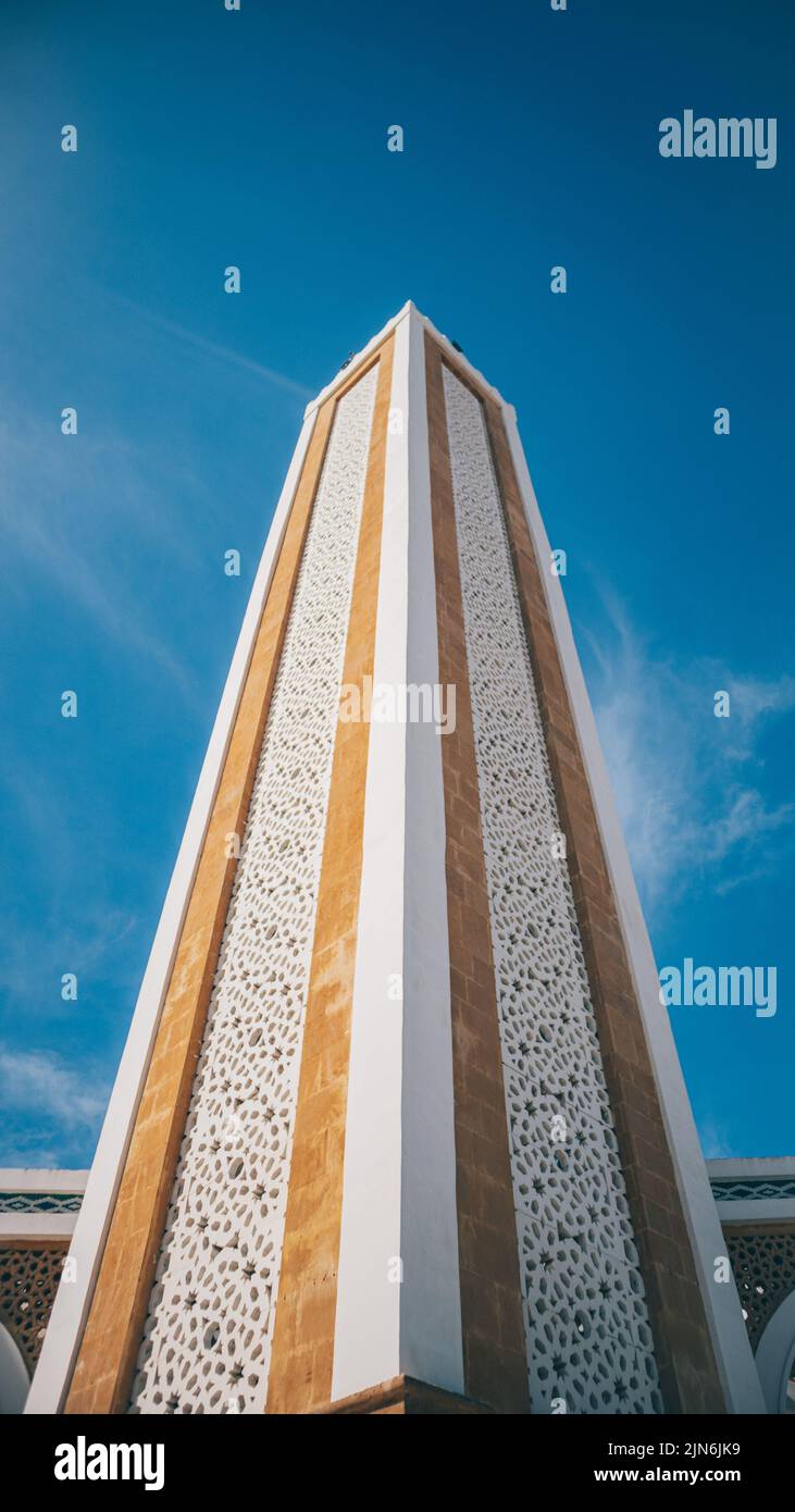 A vertical low angle shot of the beautiful Great Mosque of Tangier ...