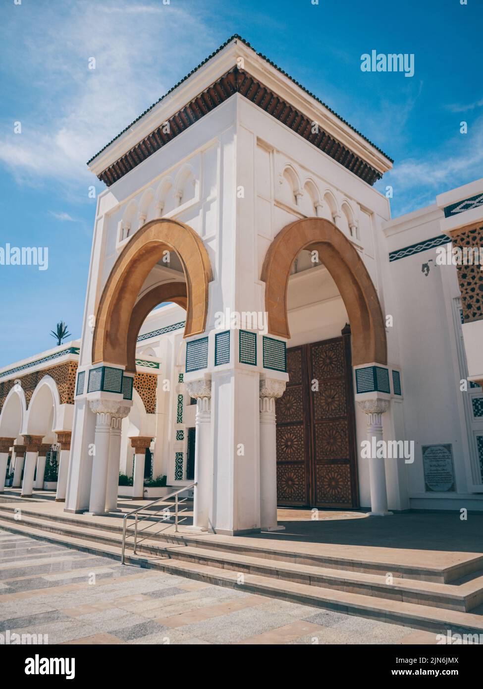 A vertical low angle shot of the beautiful entrance of the Great Mosque ...