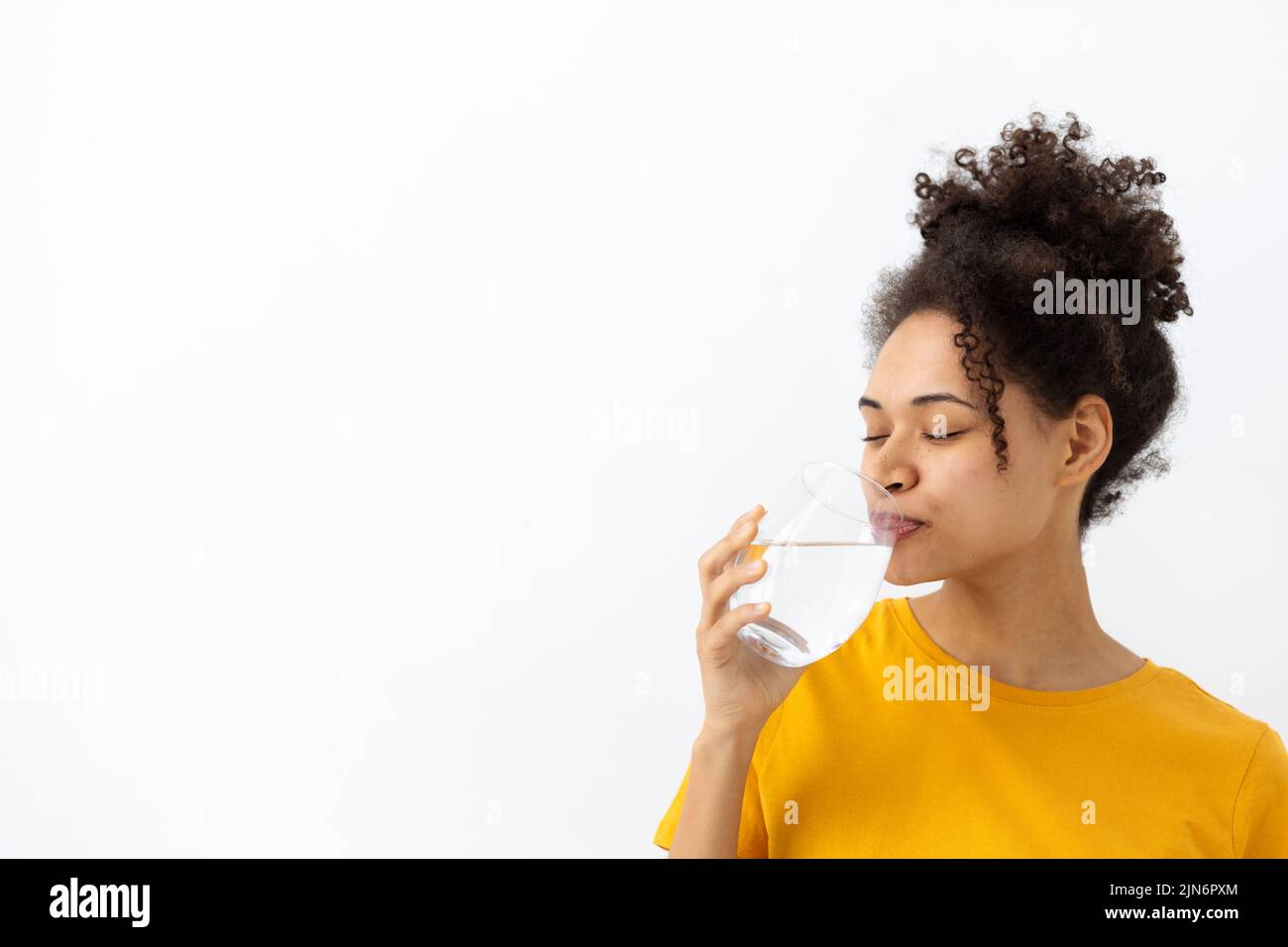 Healthy lifestyle Beautiful young Afro American woman drinking on white ...