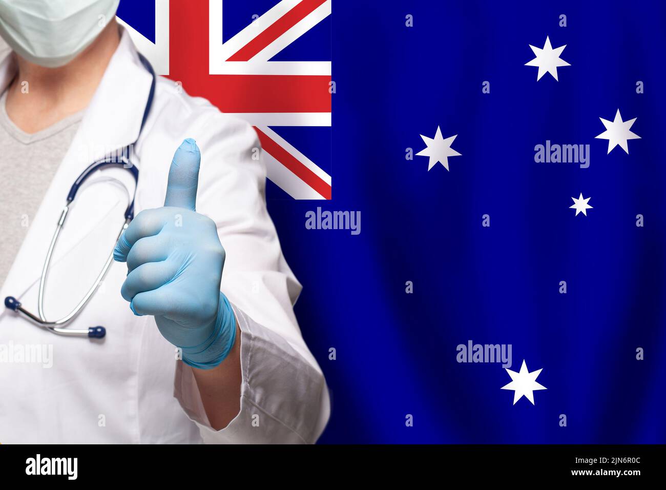 Australian doctor's hand showing thumb up positive gesture on flag of ...