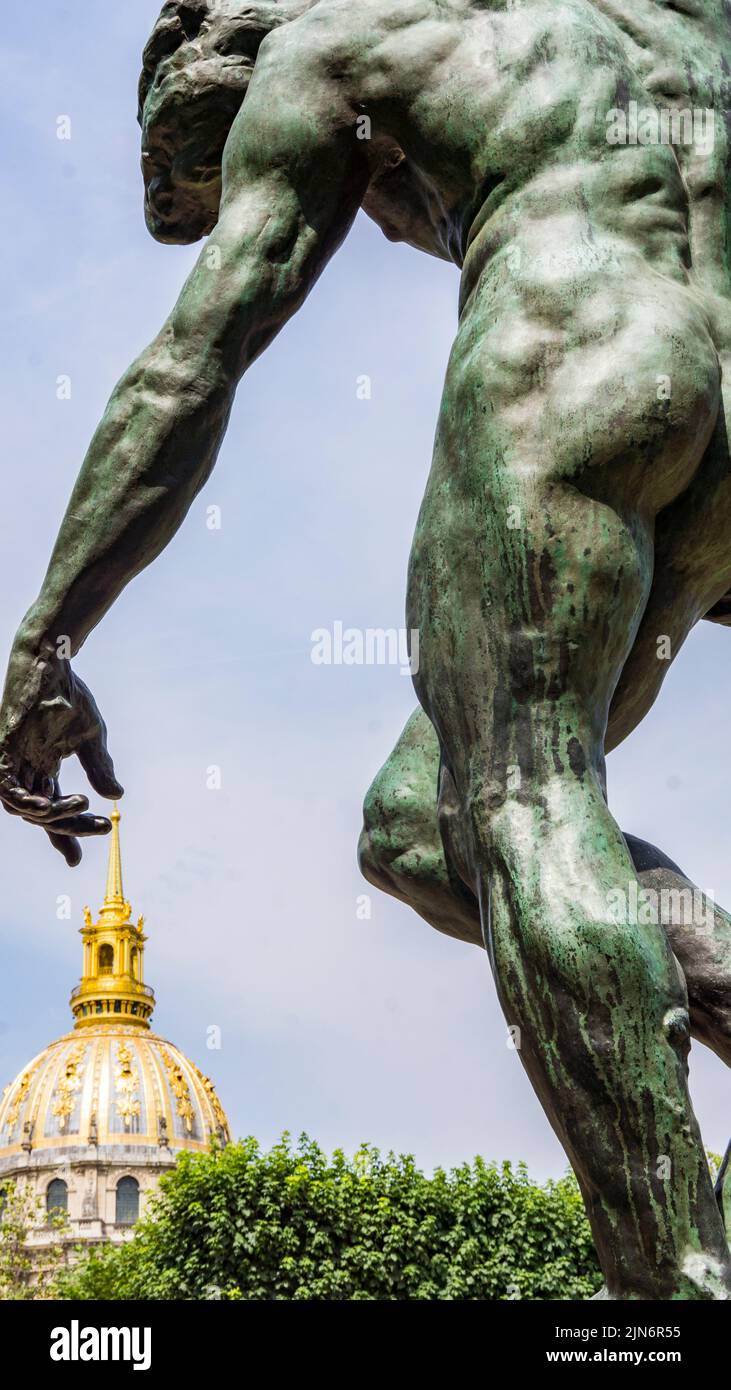 A vertical shot of the statue's hand touching Les Invalides dome. Paris ...