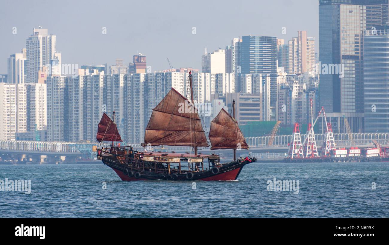 A traditional Chinese sailing ship against the background of city ...