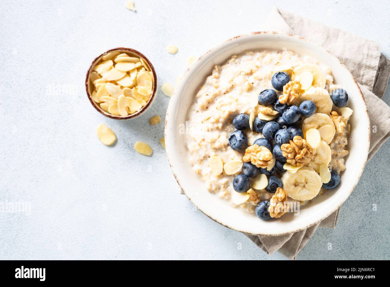 Oatmeal porrige in craft bowl at white background Stock Photo - Alamy