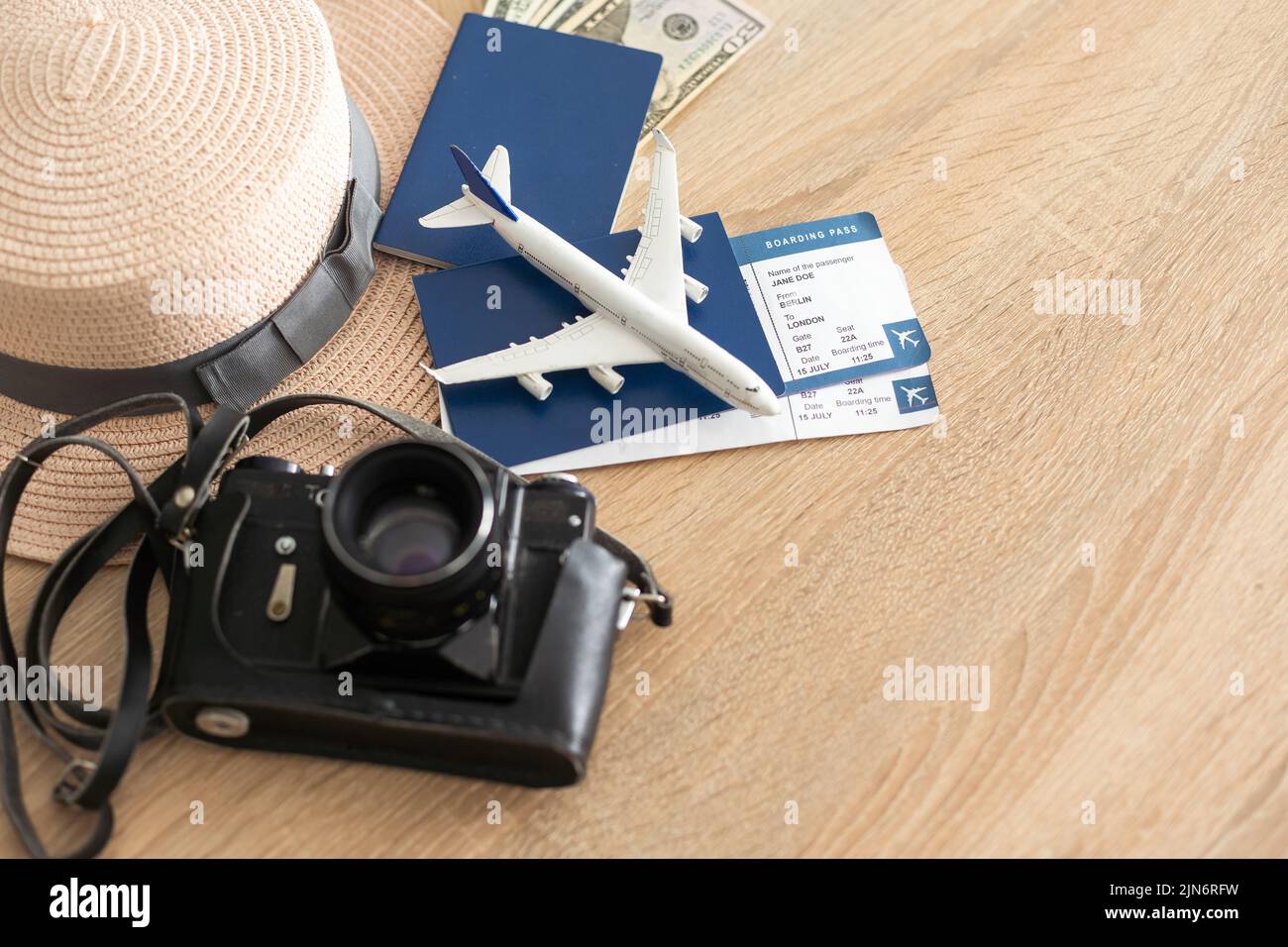 Travel concept. Airplane model, camera and passport on the table Stock ...