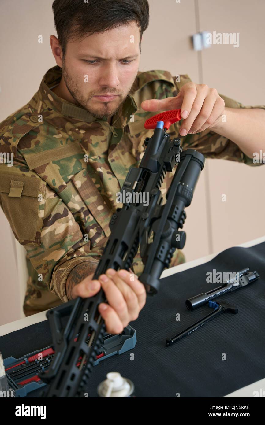 Fighter in the process of cleaning military firearms Stock Photo - Alamy