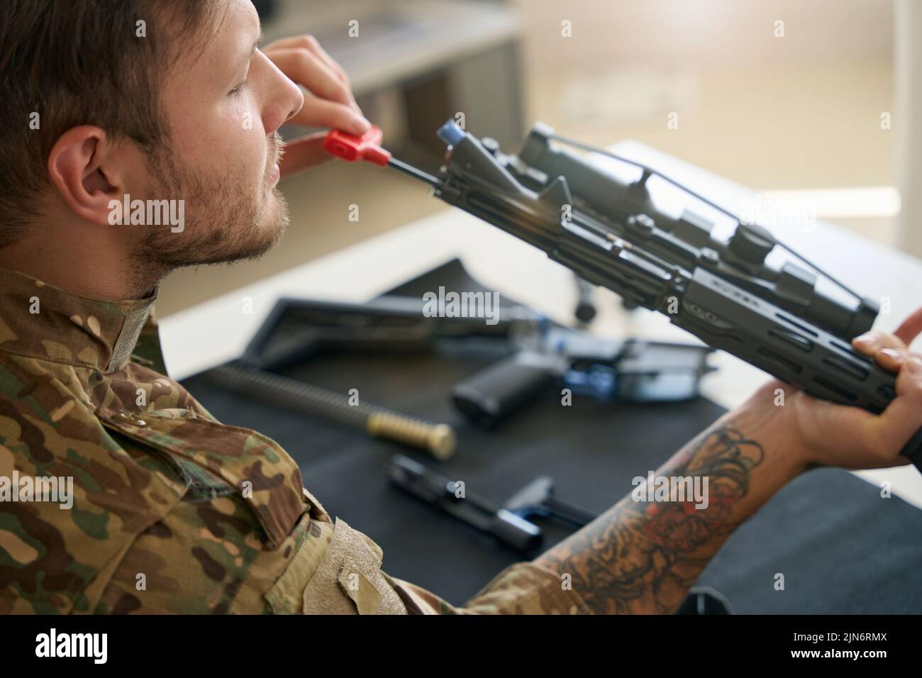 Military man is cleaning his disassembled firearm Stock Photo - Alamy