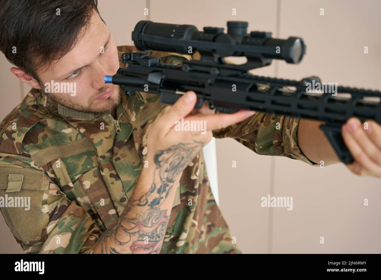 Infantryman inspects and checks his combat firearm Stock Photo - Alamy