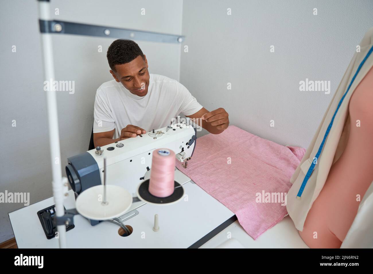 Male tailor using sewing machine at work Stock Photo - Alamy