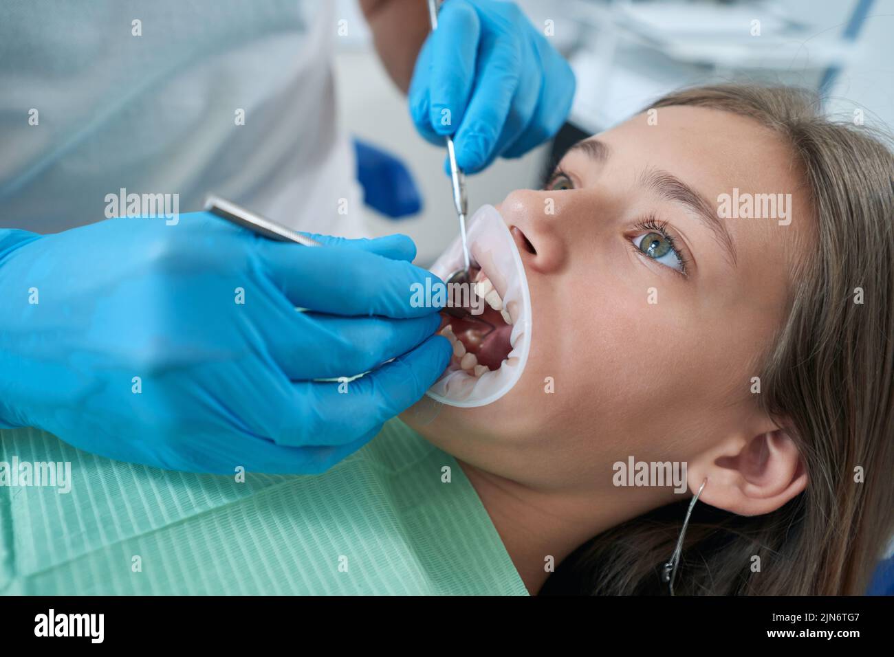 Pedodontist examining teeth and gums of adolescent girl Stock Photo - Alamy