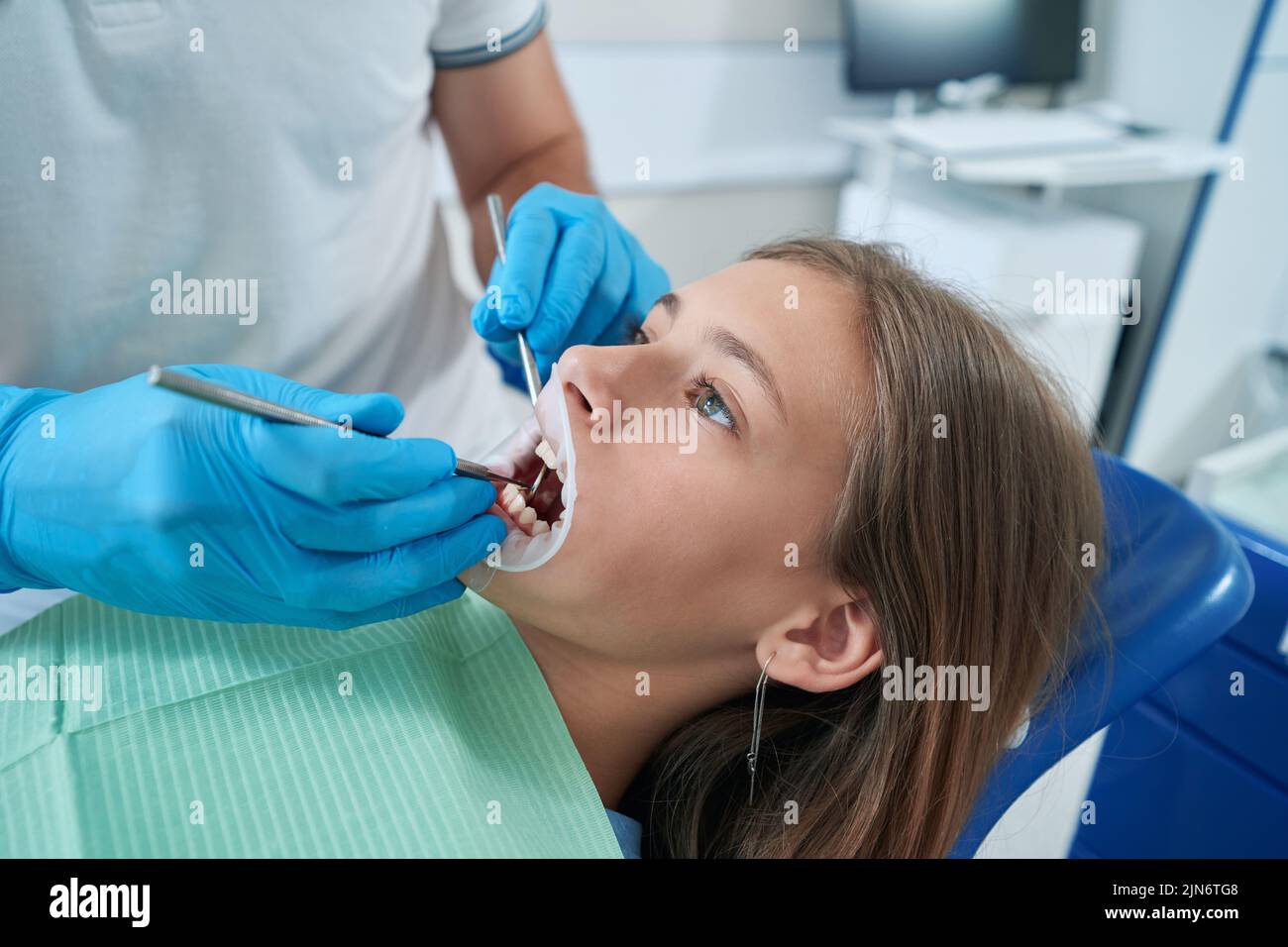 Stomatologist inspecting oral cavity of young patient Stock Photo - Alamy