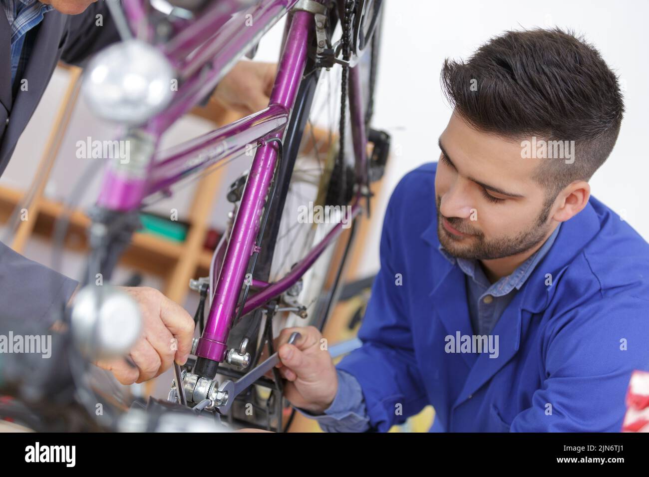 portrait of men assembling a bicycle Stock Photo - Alamy