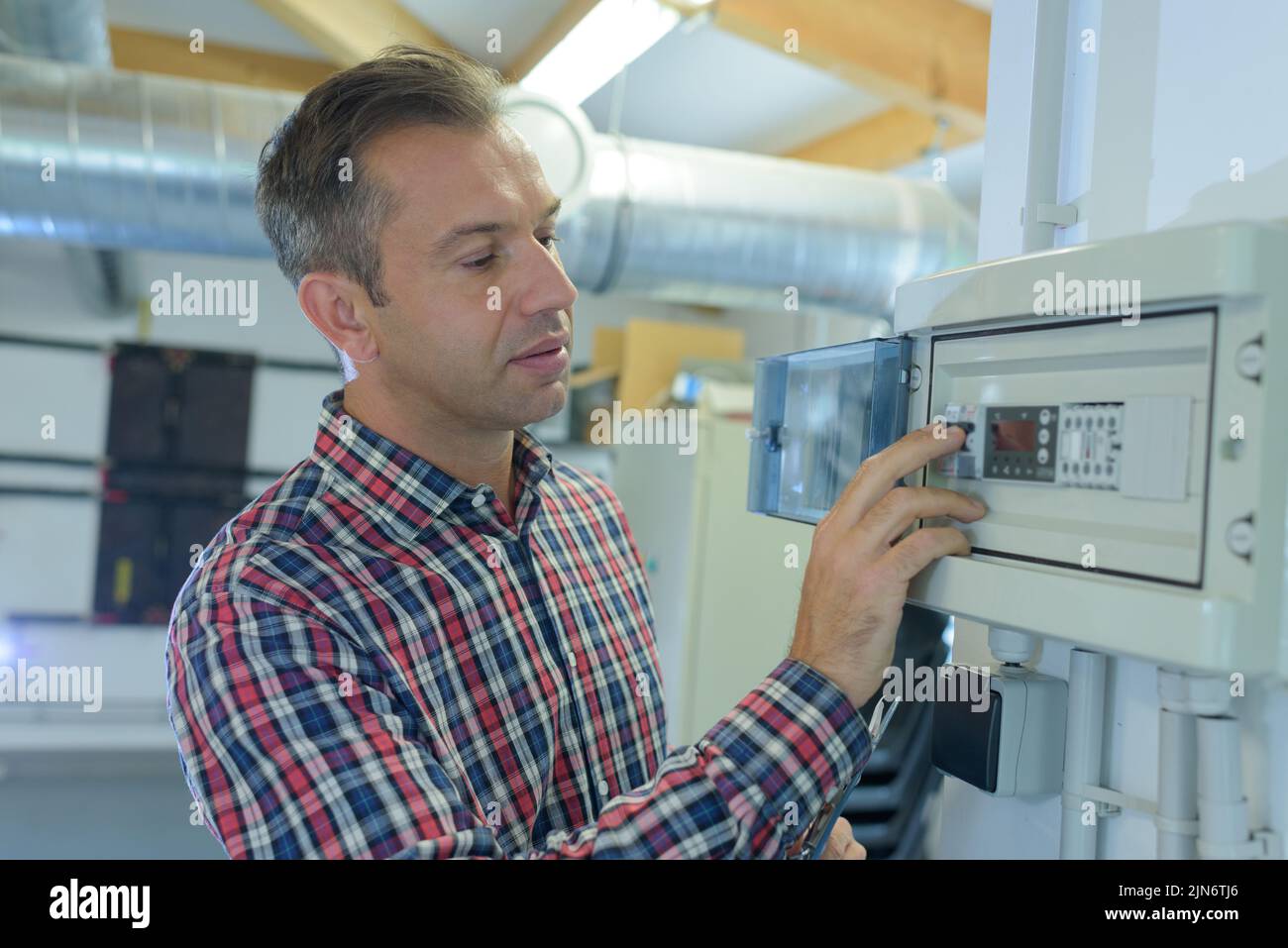 man operating machine units in modern factory Stock Photo - Alamy