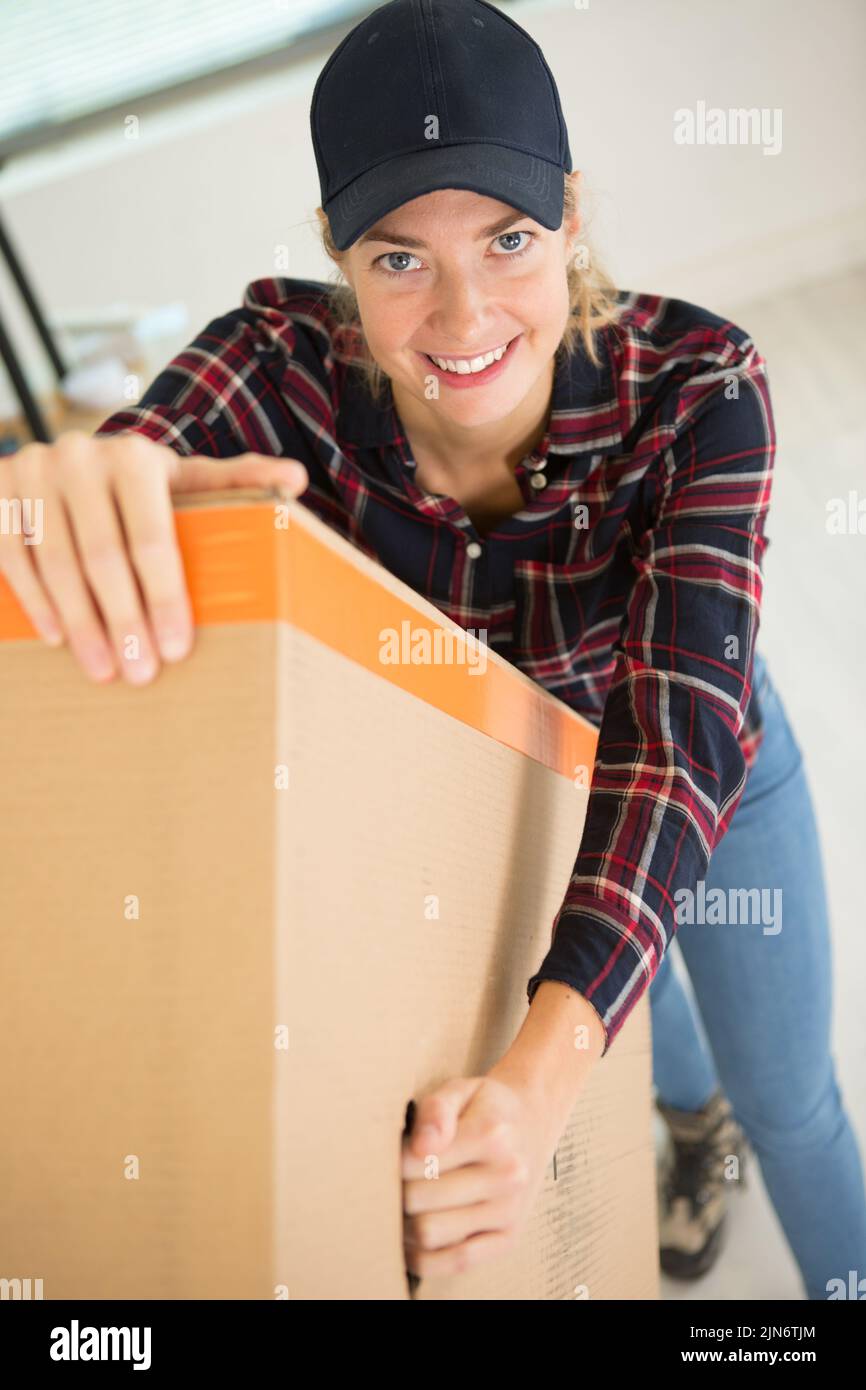 female worker carrying a box Stock Photo - Alamy