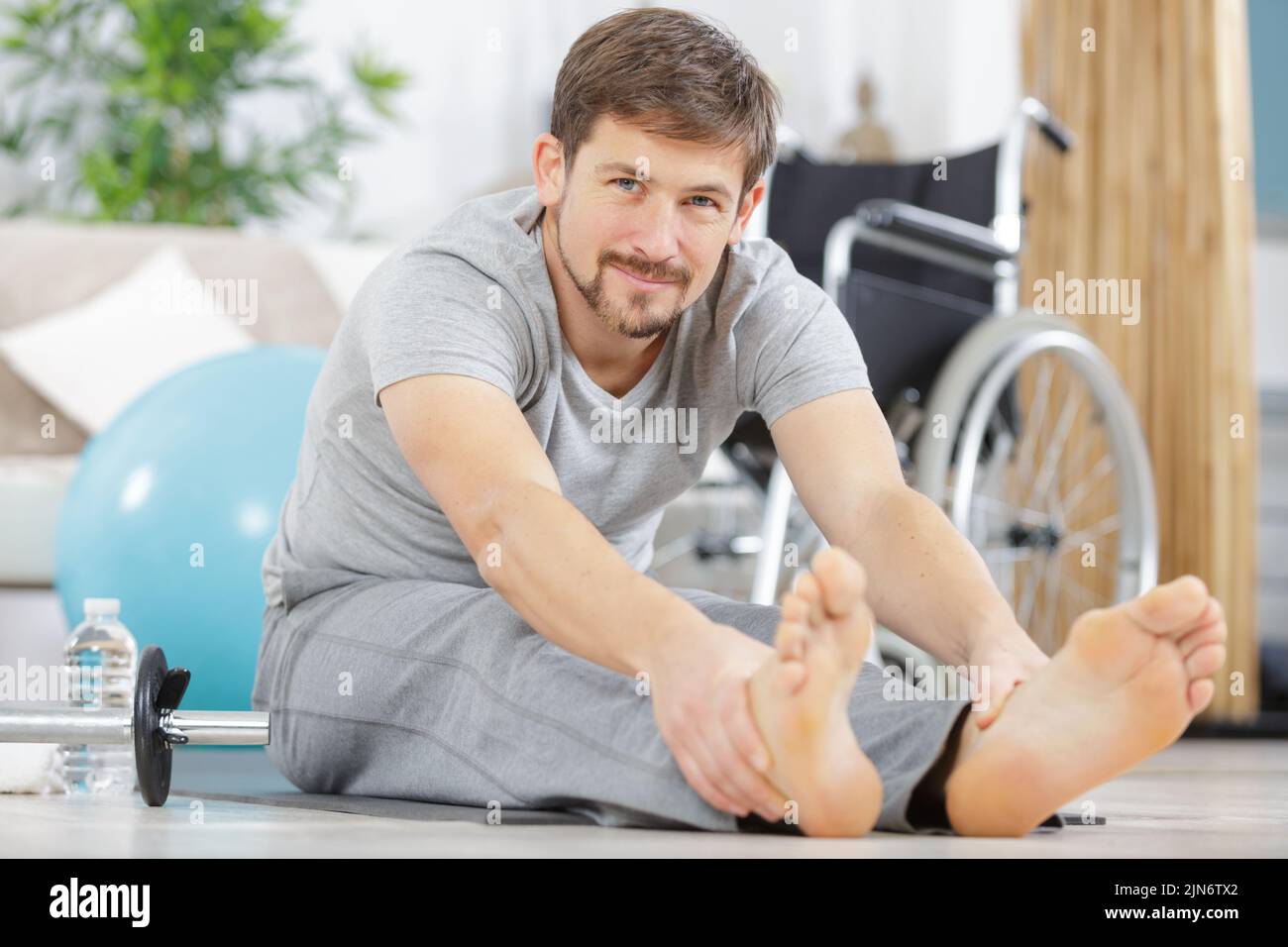 healthy man stretching leg before workout Stock Photo - Alamy