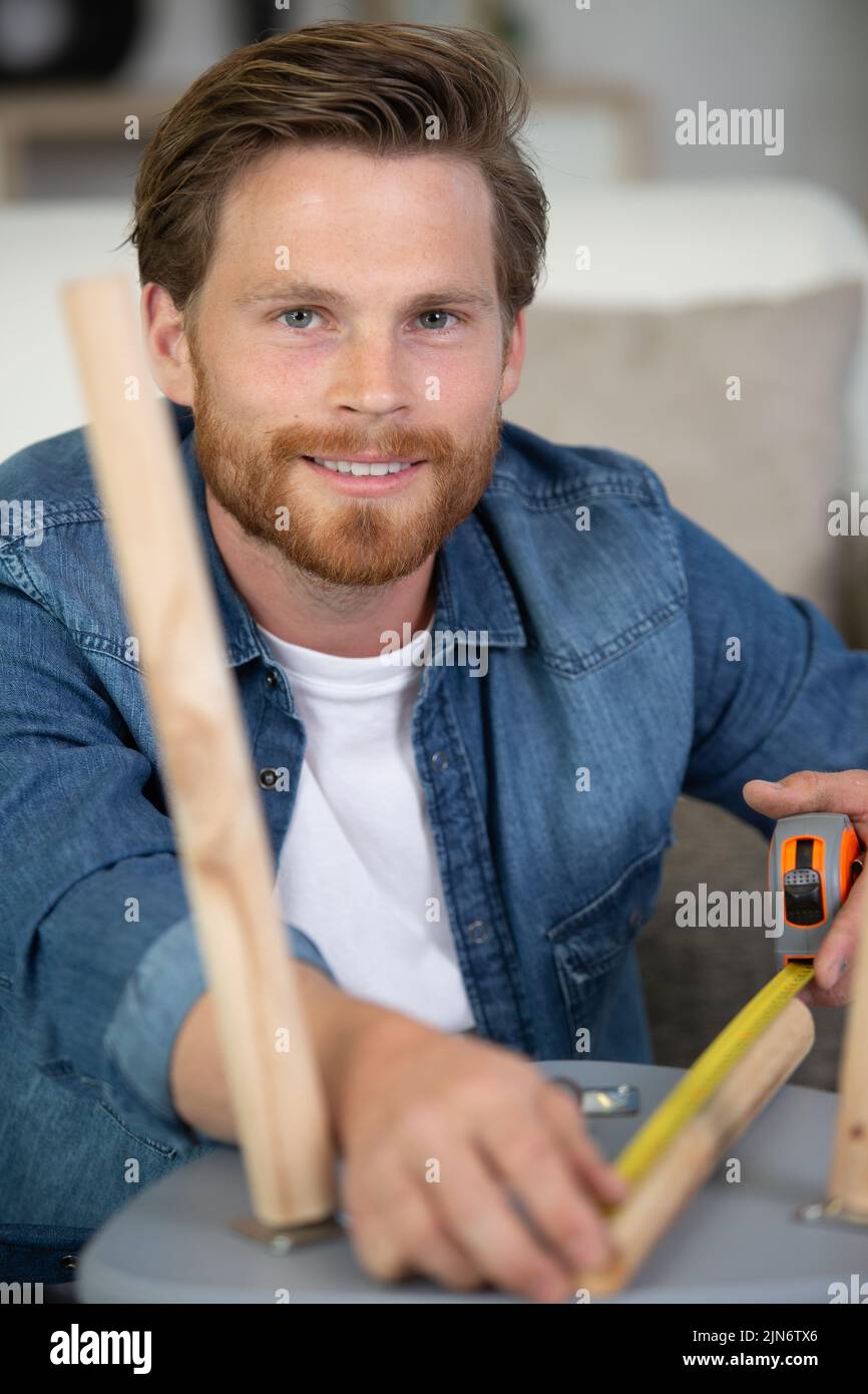 man measuring and checking size of an antique chair Stock Photo - Alamy