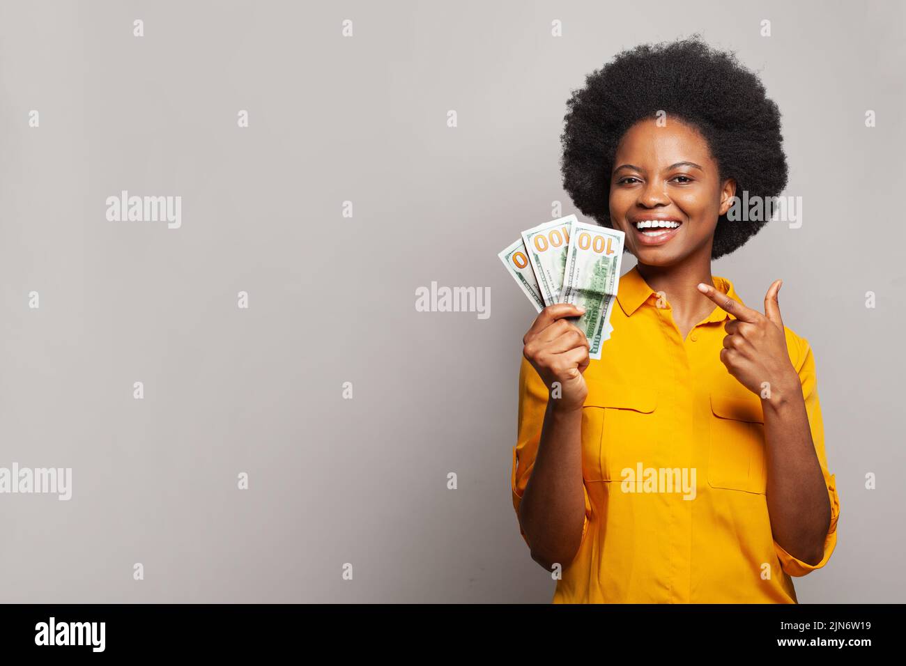 Woman winning money. Happy woman with surprised expression holding ...