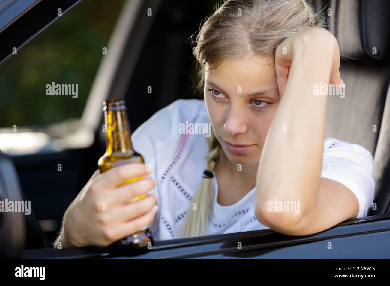 a depressed woman drunk driving Stock Photo - Alamy