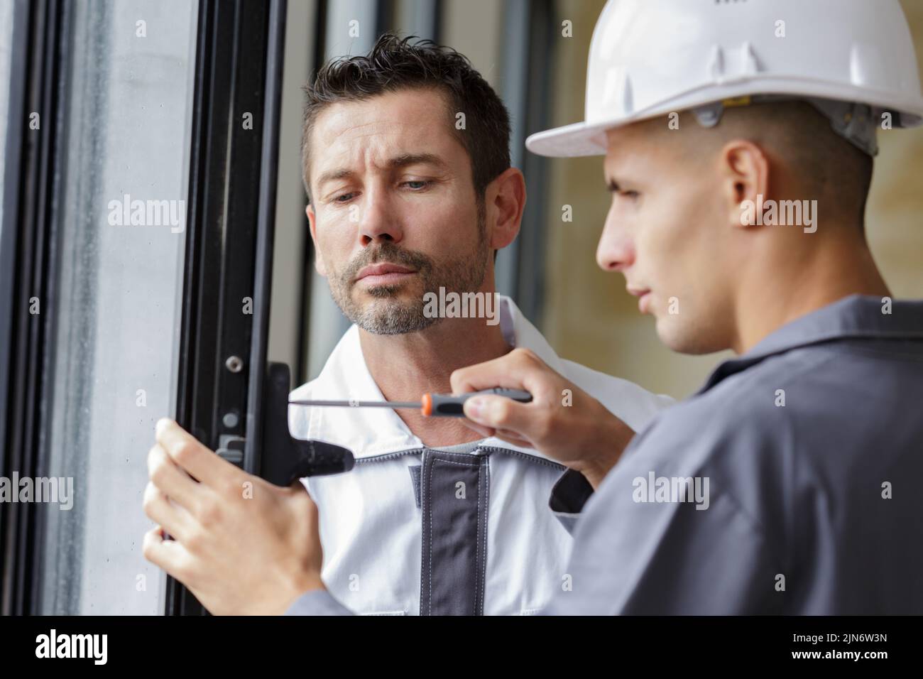 window and door glazing installer apprentice Stock Photo - Alamy