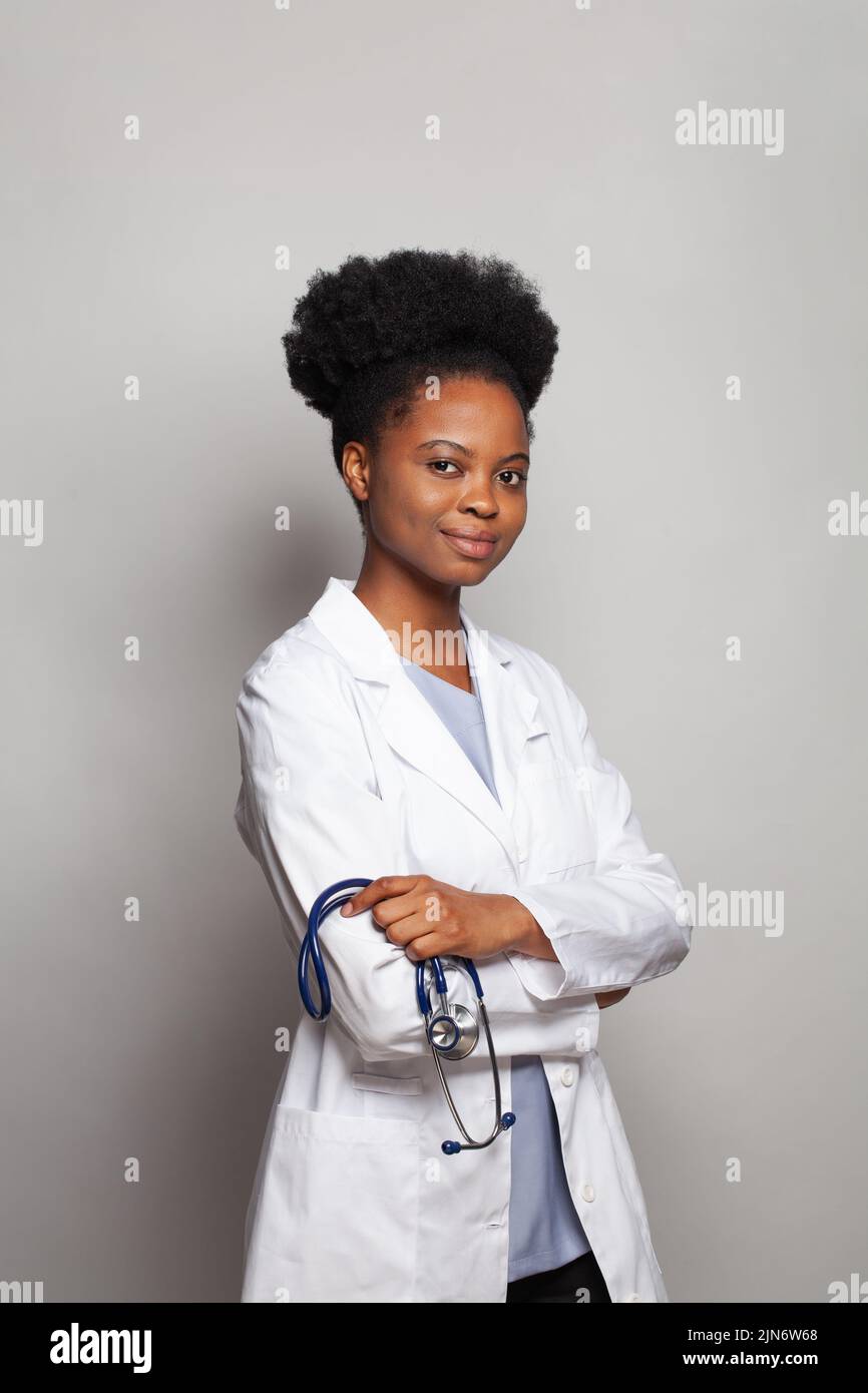 Smiling medical physician doctor posing on grey background Stock Photo ...