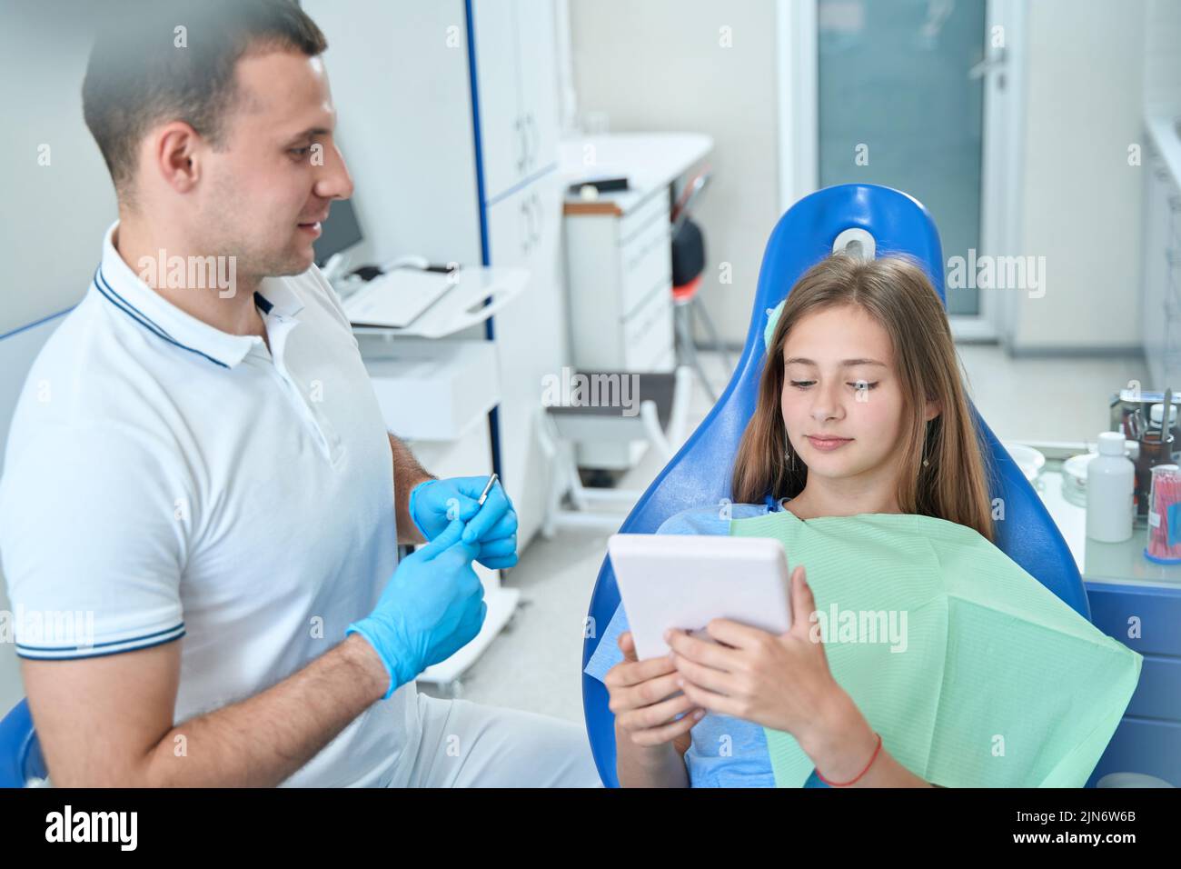 Teenage patient sitting in dentist office at initial consultation Stock ...