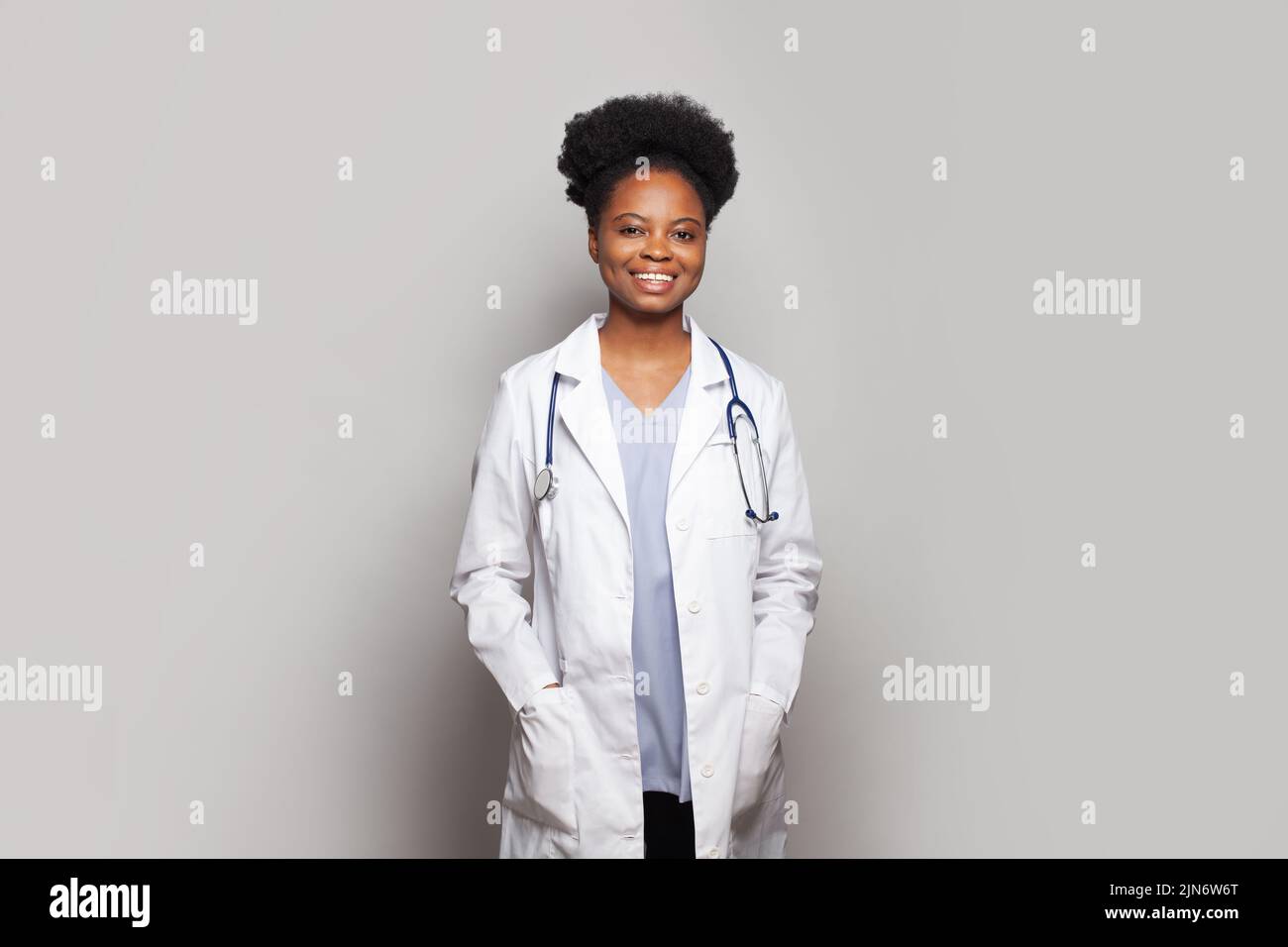 Happy smart doctor woman smiling on white background Stock Photo - Alamy